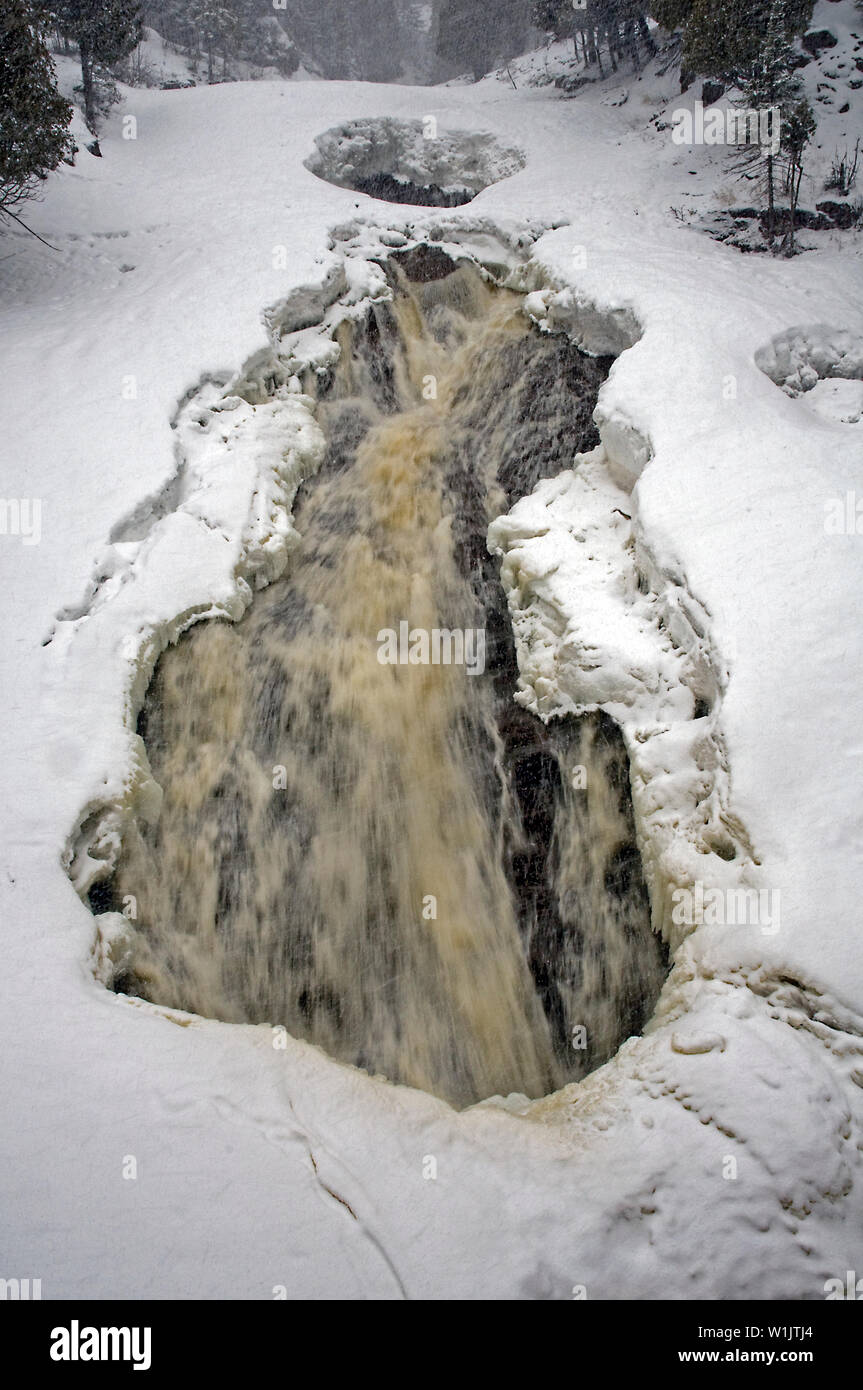 Northern Minnesota's Cross River cascades through ice and snow as it ...