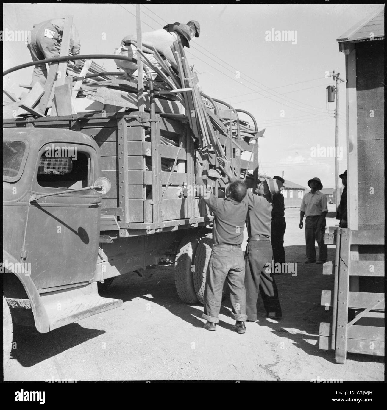 Topaz, Utah. Volunteer workers delivering scrap wood to be used as ...