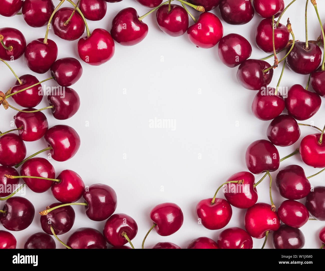 Delicious ripe red cherries on the white background arranged in the ...