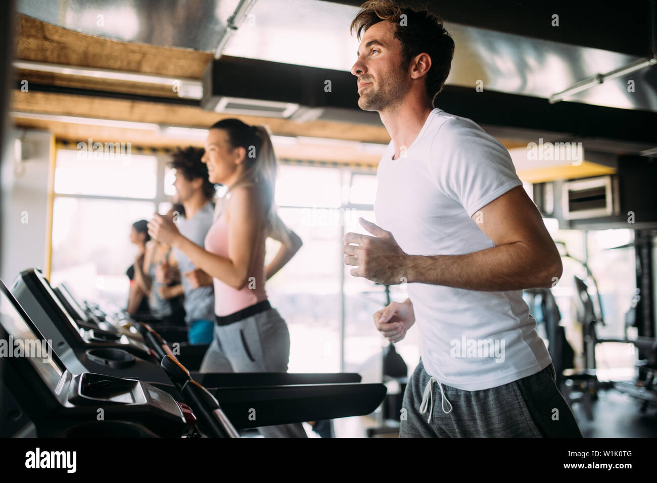 Happy gorup of healthy people training in gym Stock Photo - Alamy