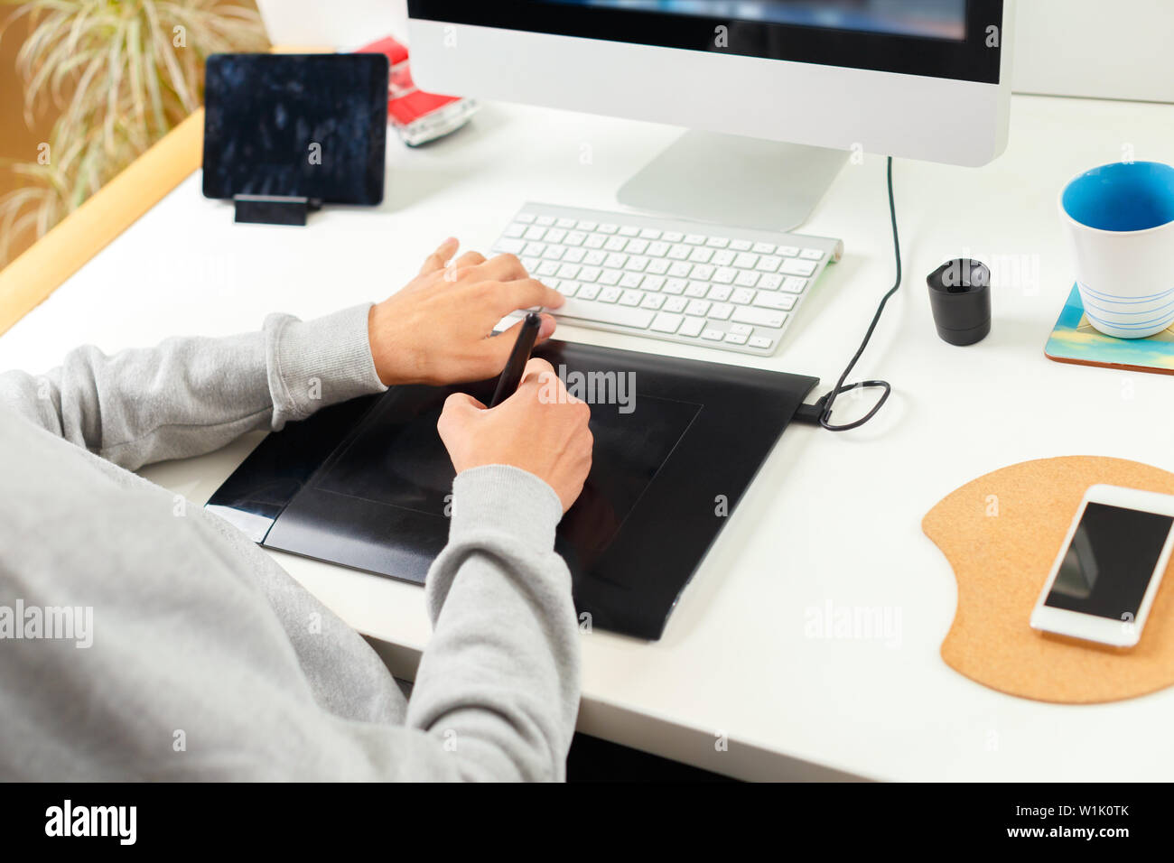 Designer using graphic tablet at office Stock Photo - Alamy