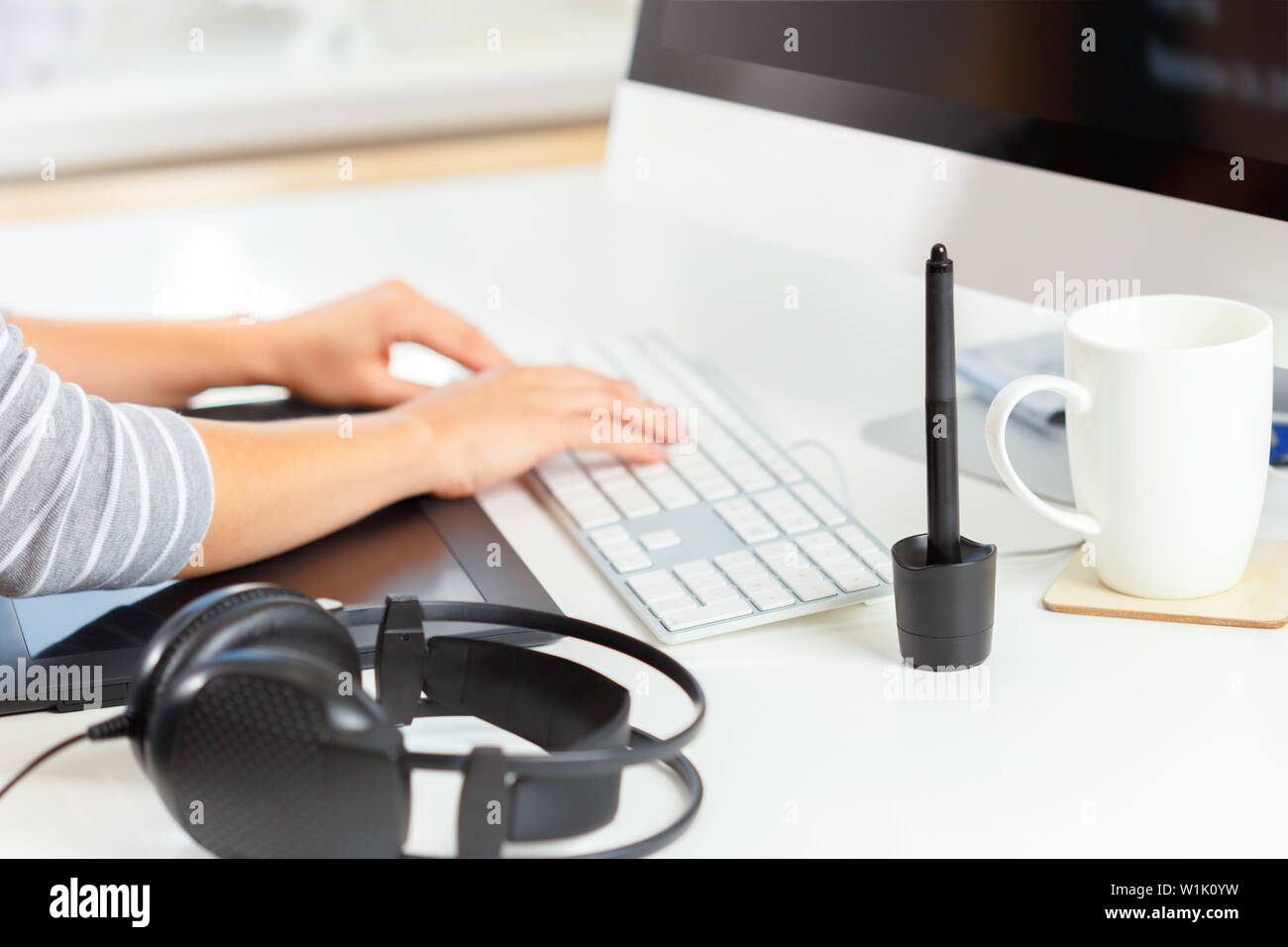 Designer using graphic tablet at office Stock Photo - Alamy