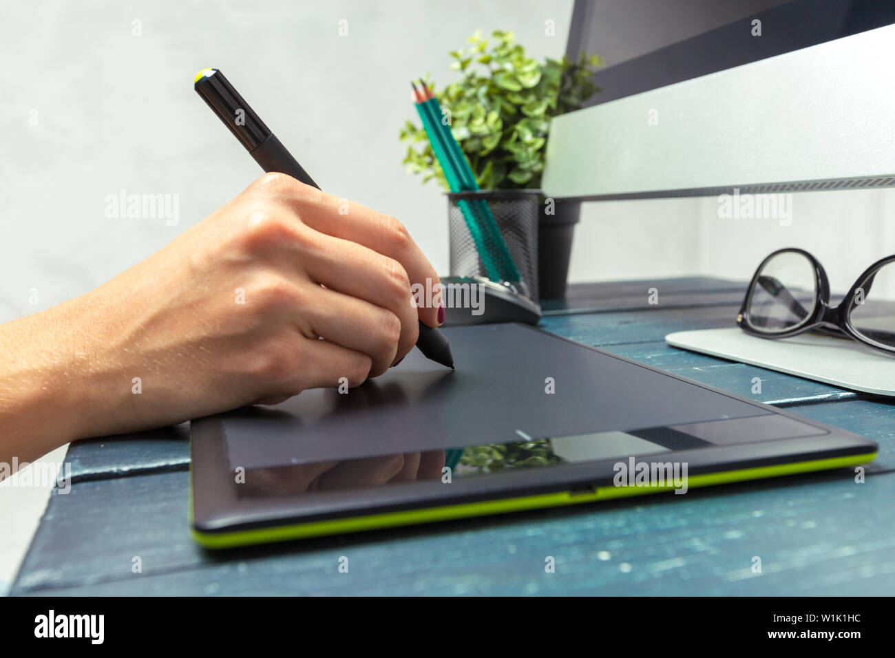 Hand of graphic designer working with stilus and tablet Stock Photo - Alamy