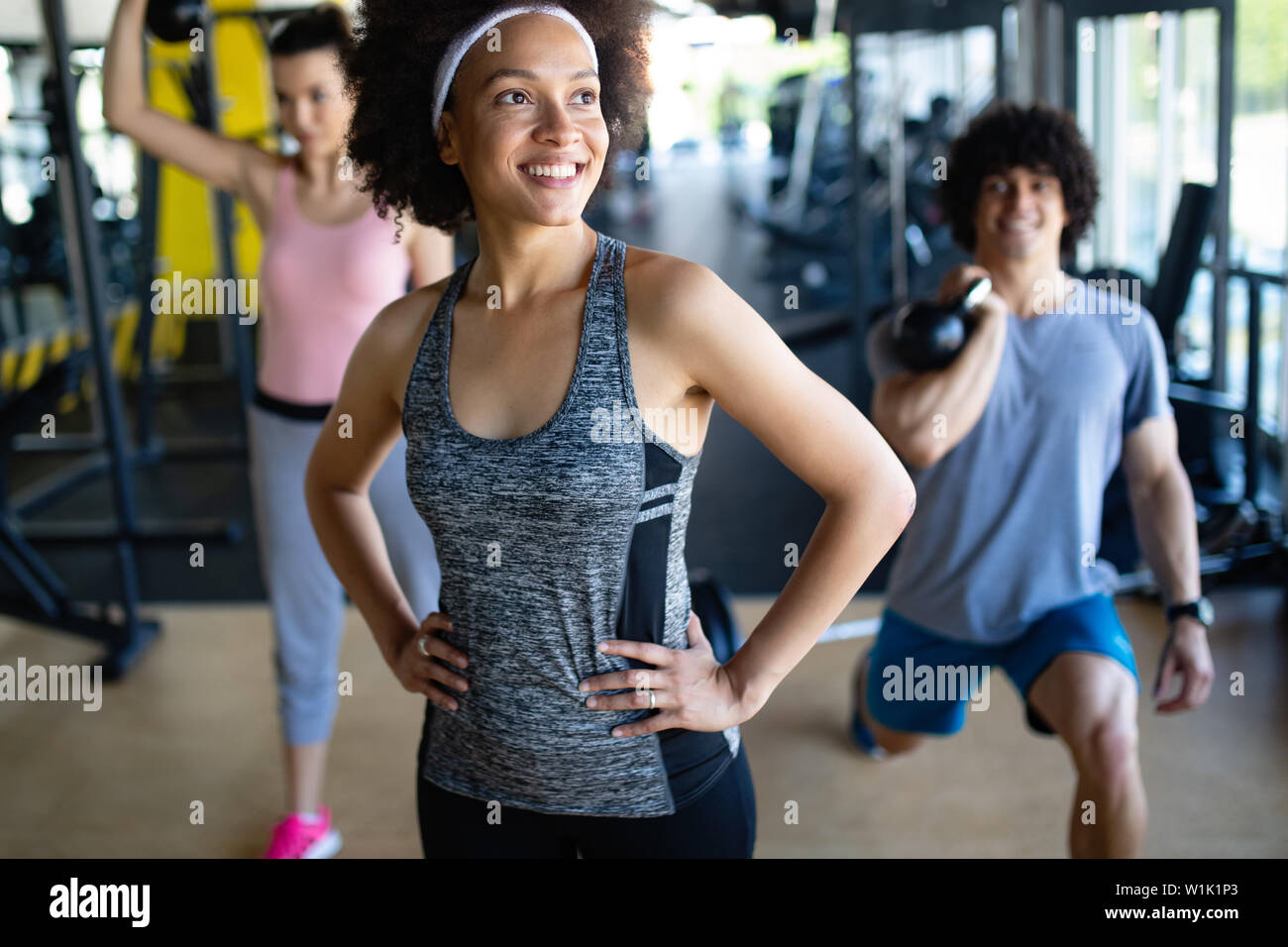 Happy gorup of healthy people training in gym Stock Photo - Alamy