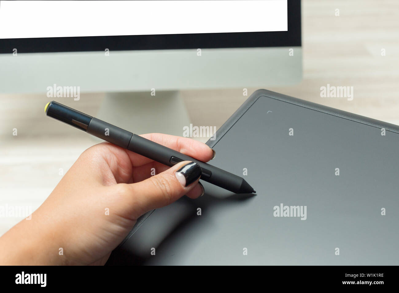 Hand of graphic designer working with stilus and tablet Stock Photo - Alamy