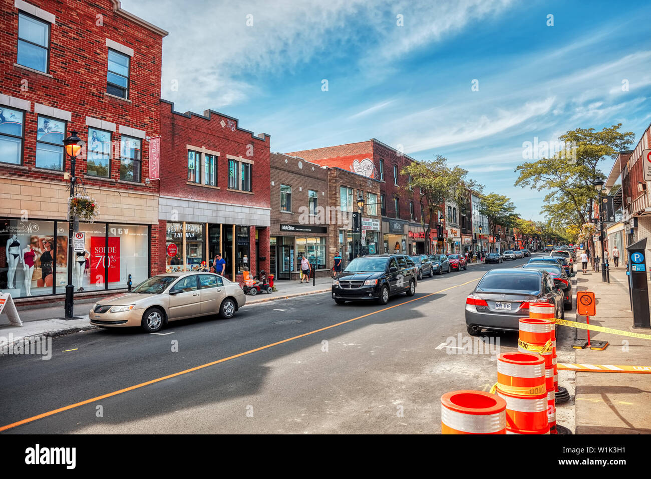 People and cars on Mont royal avenue on a sunny summer day in Montreal ...