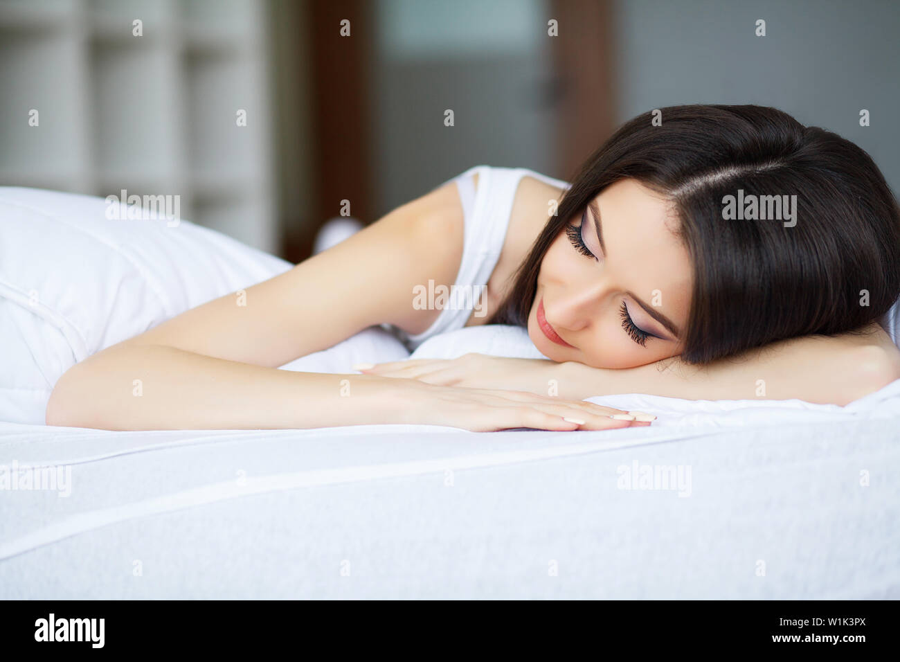 Beautiful woman lying and sleep on the snowy bed Stock Photo - Alamy
