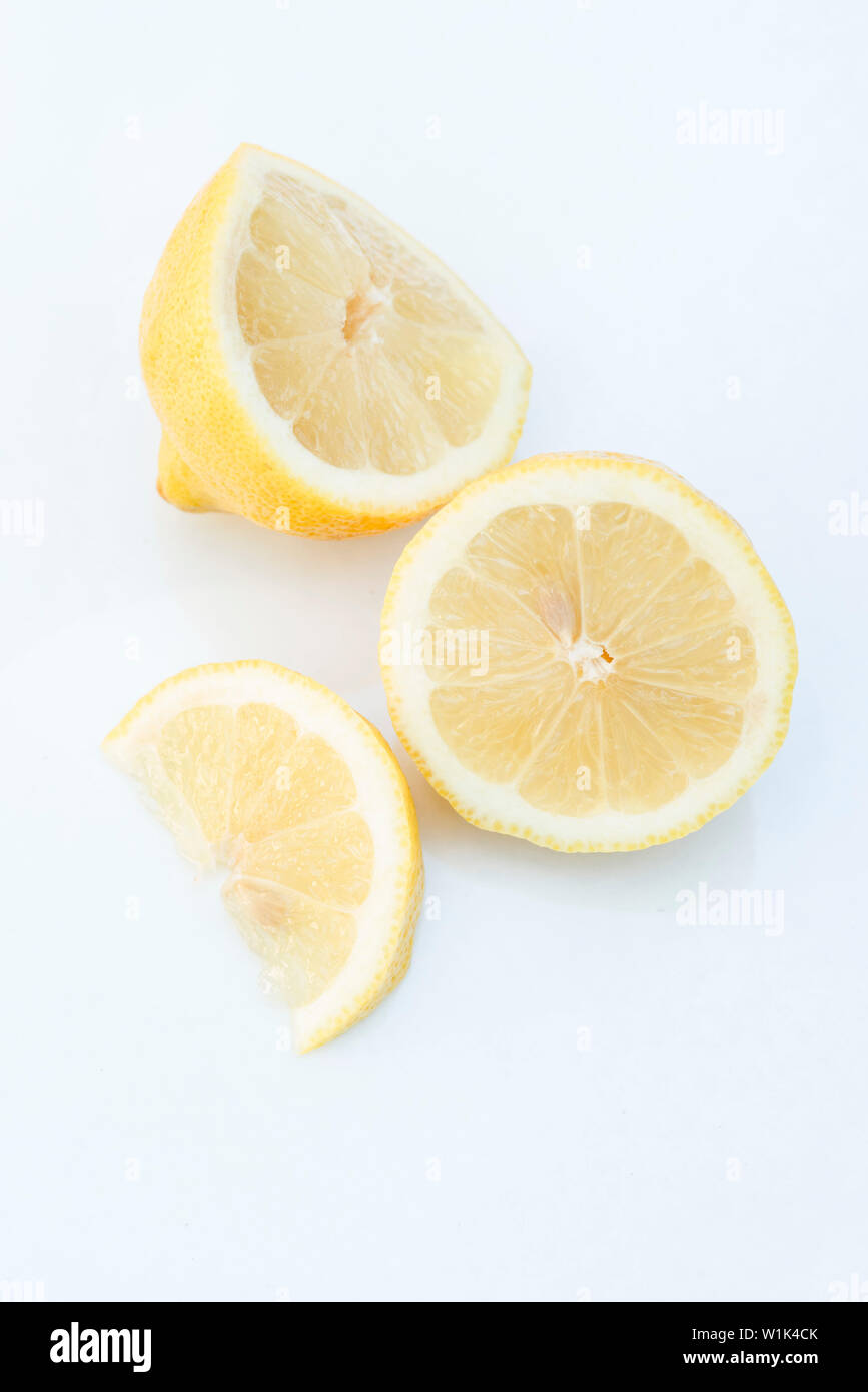 Cut lemon and lemon wedge arranged on a white background Stock Photo ...