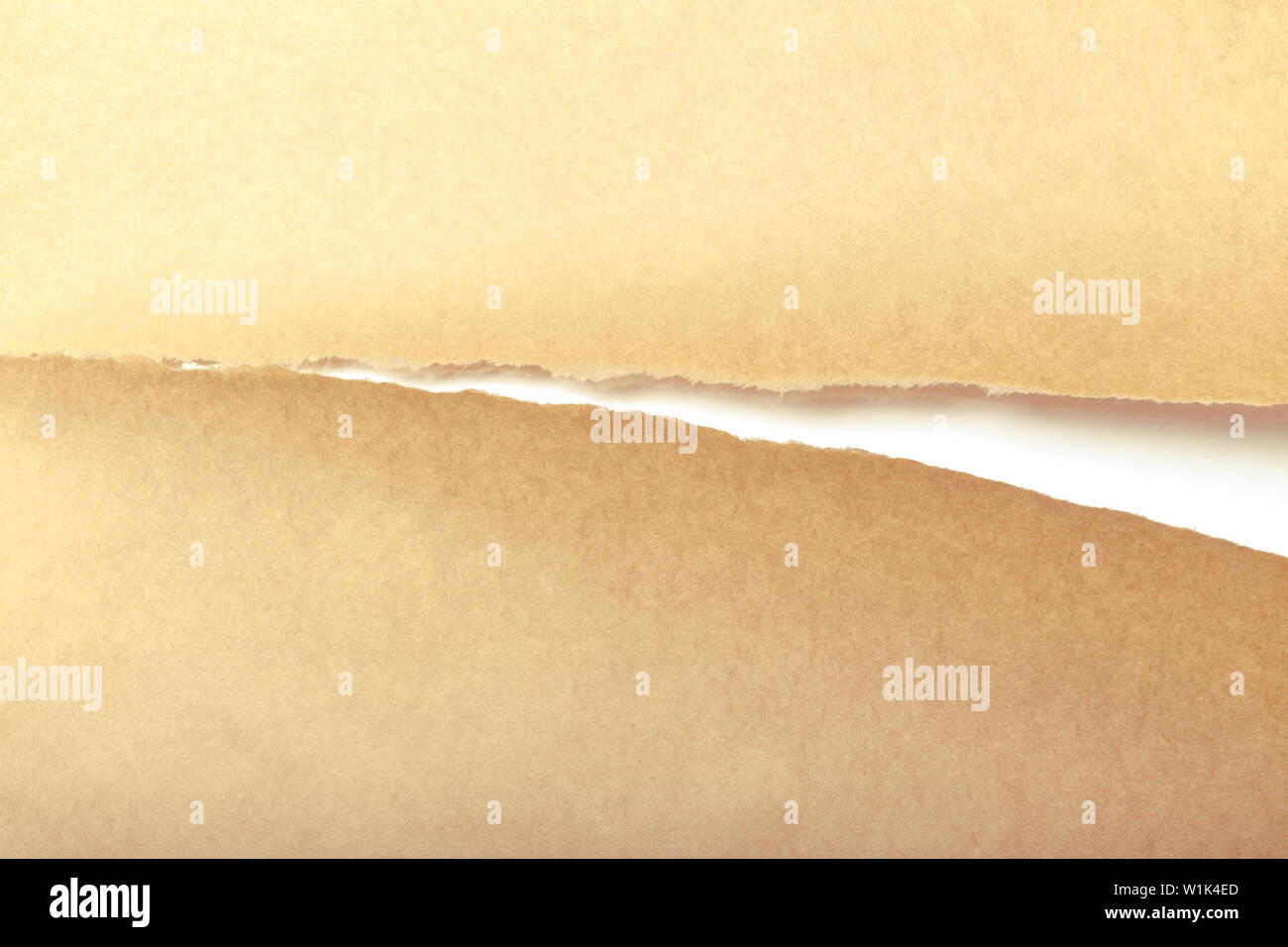 Brown package paper torn to reveal white panel Stock Photo - Alamy