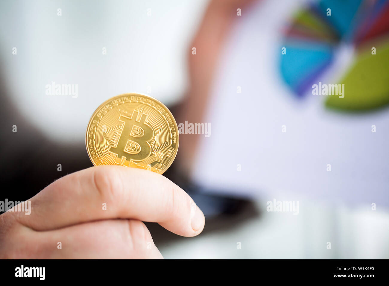 The man is holding bitcoins in his office Stock Photo - Alamy