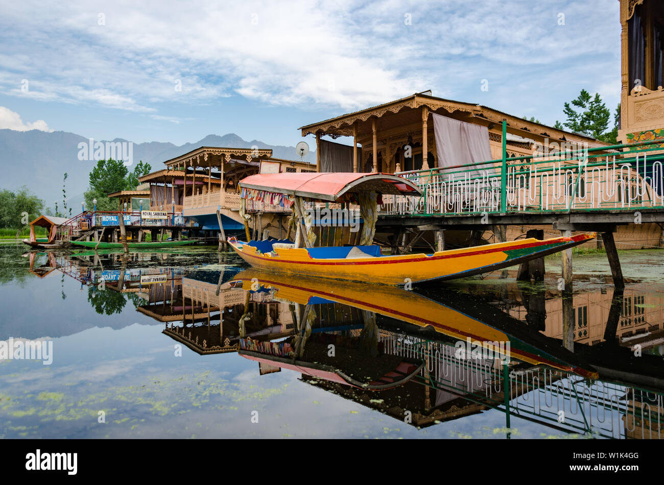 Perfect reflection of houseboats and shikara in the still waters of Dal ...