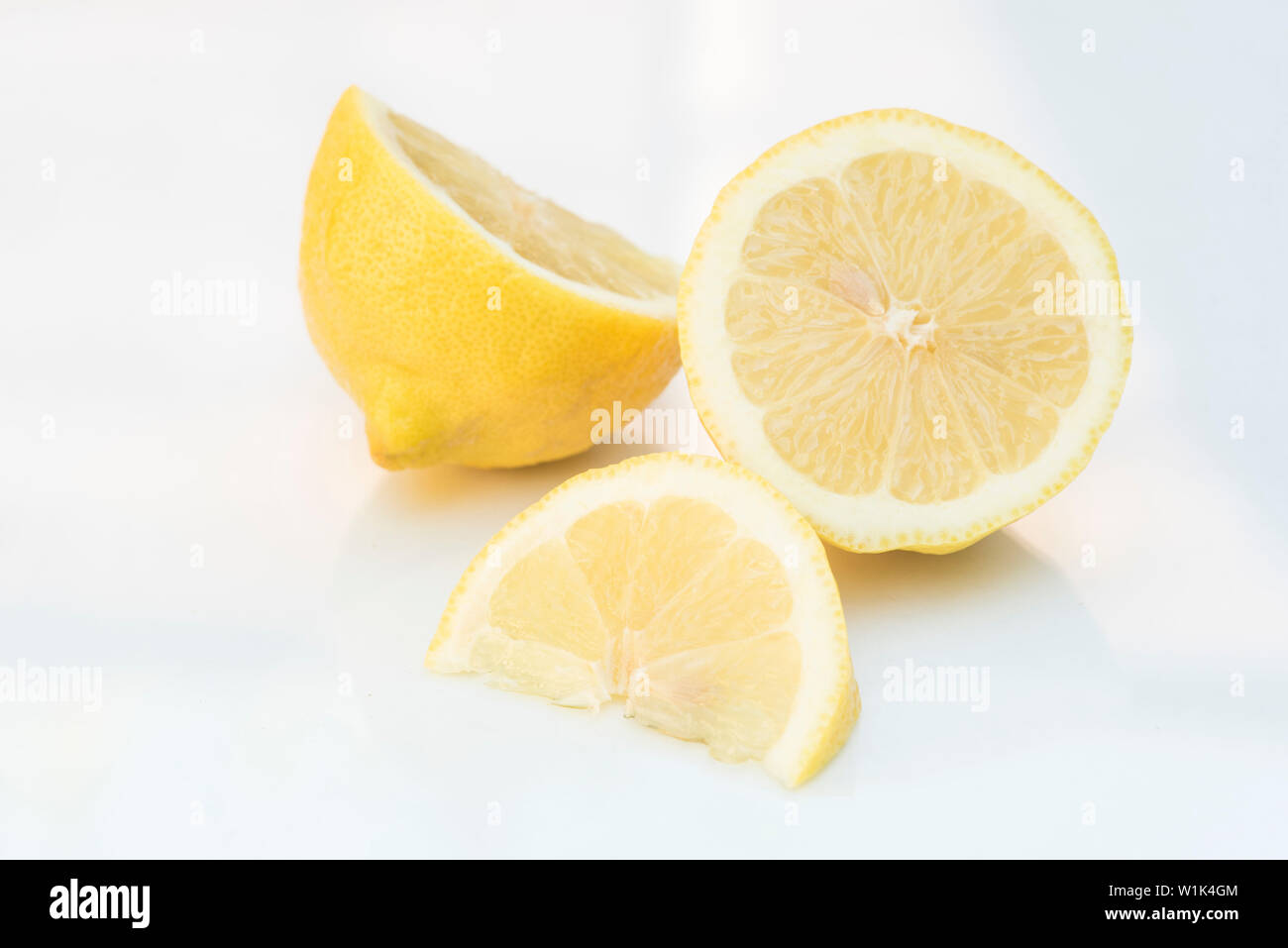 Cut lemon and lemon wedge arranged on a white background Stock Photo ...