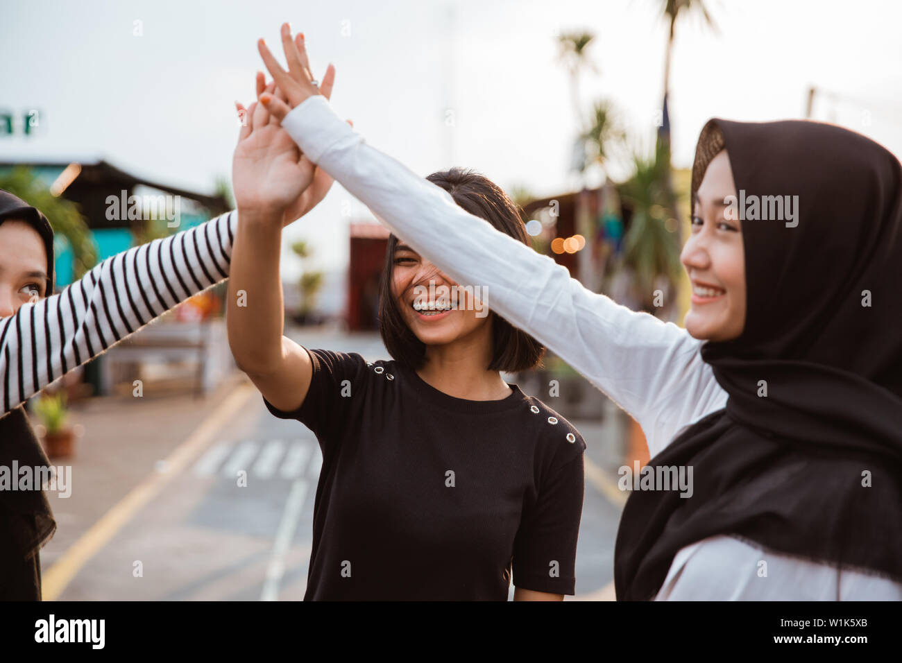 young people raised hands together Stock Photo - Alamy