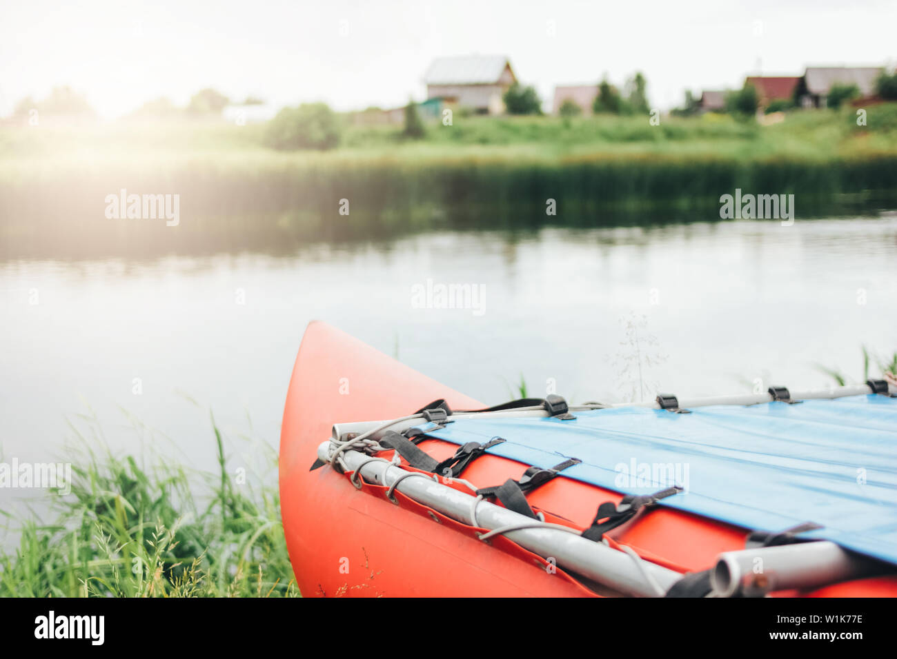 Inflatable catamaran for river rafting and fishing on the grass shore ...