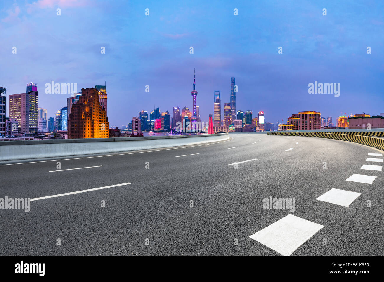 Shanghai skyline panoramic view with asphalt highway at night,China ...