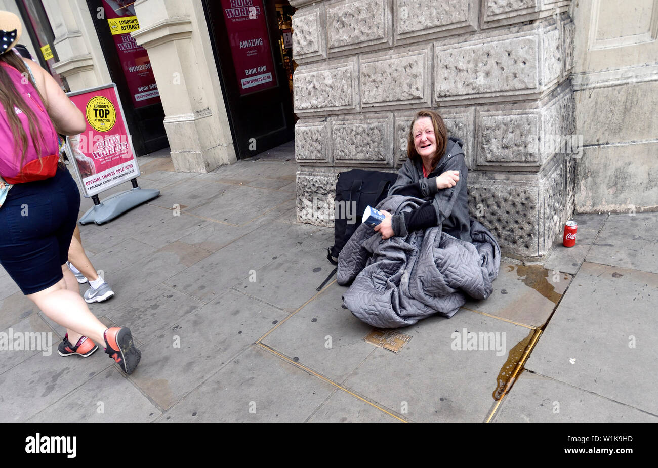 London, England, UK. Homeless woman on the pavement in Regent Street ...