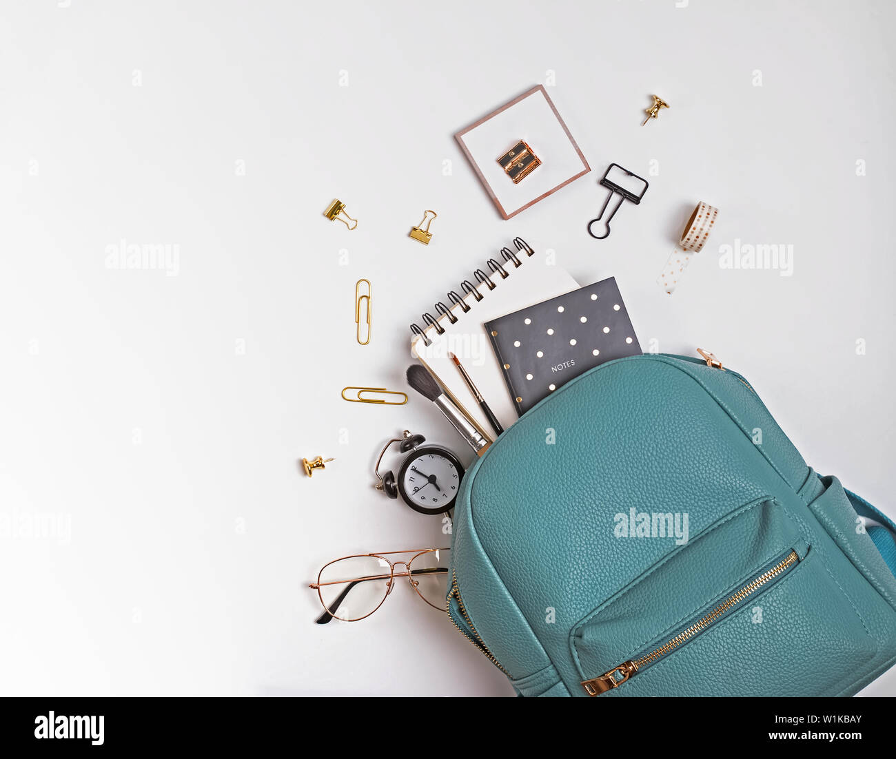 Student's backpack with different stationery and study supplies on the ...