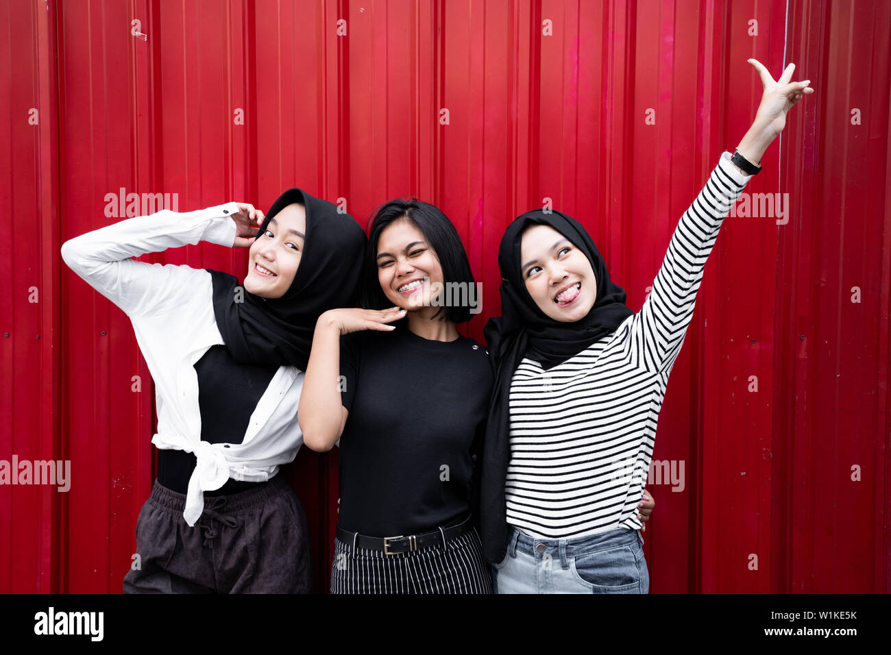 three women standing pose Stock Photo - Alamy