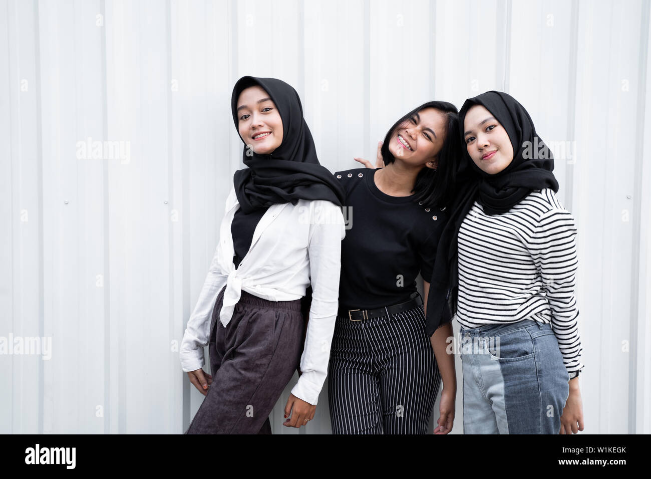 three women standing pose Stock Photo - Alamy