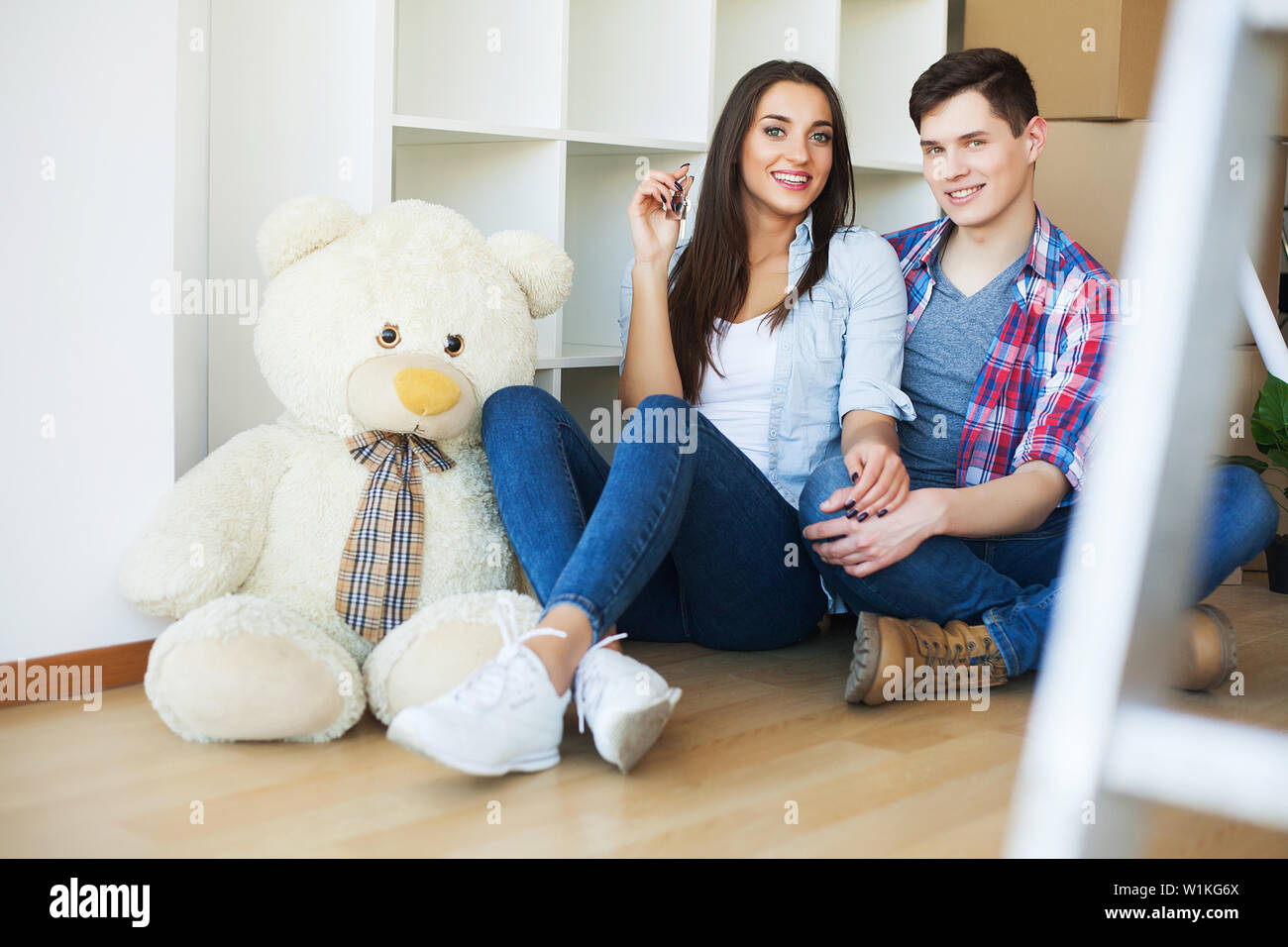 Happy young couple moving together in new apartment Stock Photo - Alamy