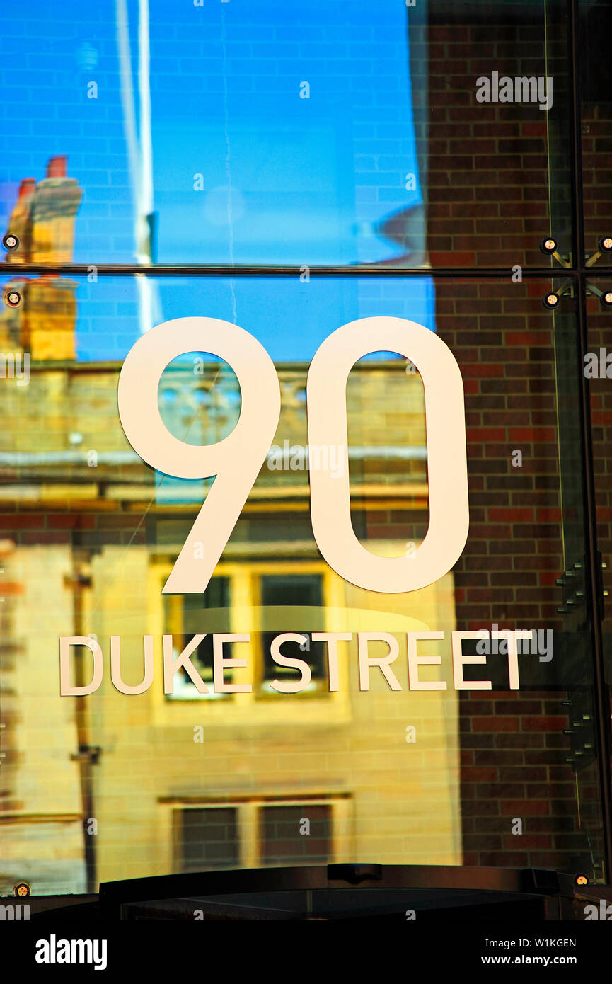Reflections in the glass fronted building at number 90 Duke Street ...