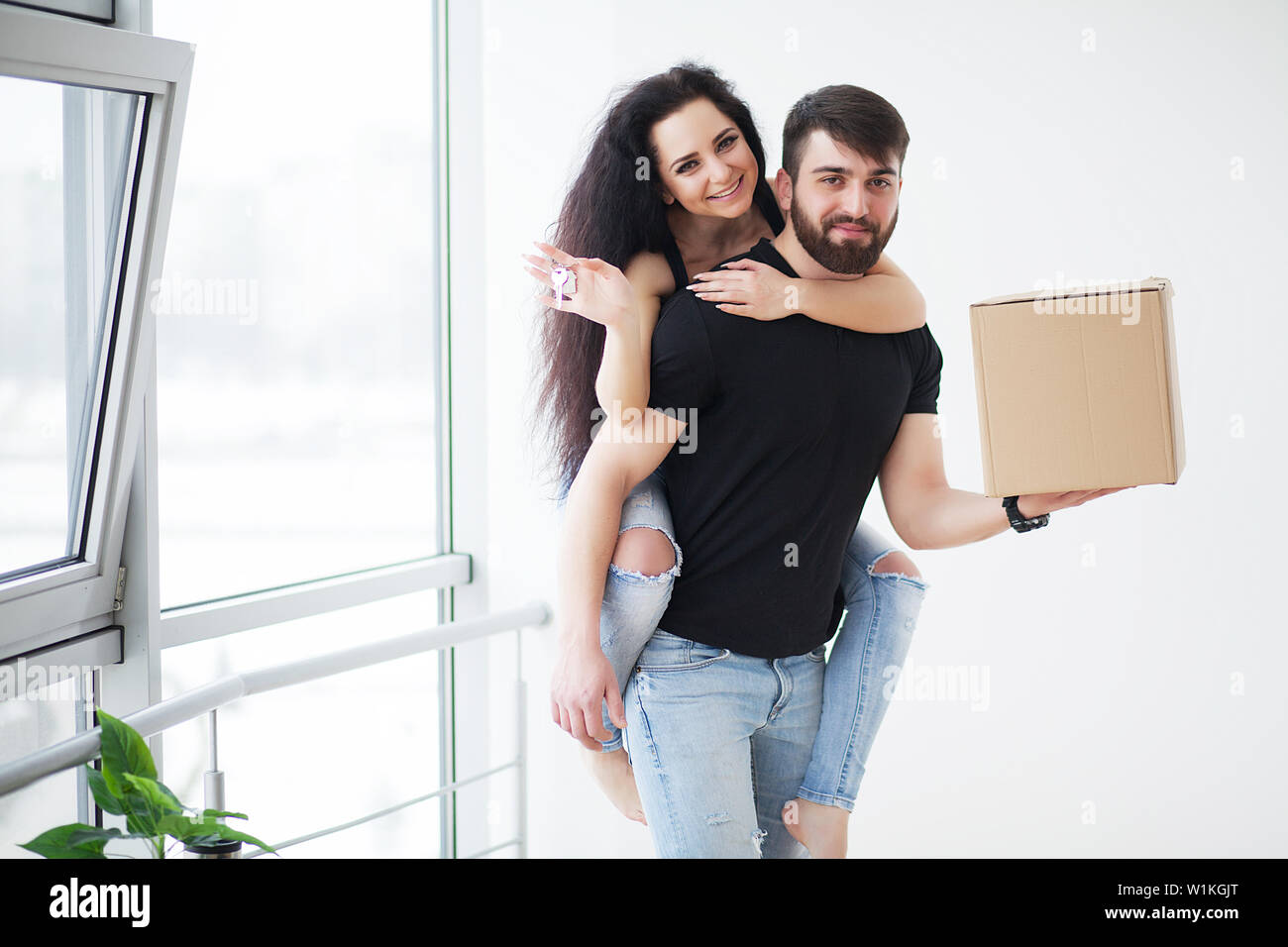 Young happy couple talking while standing at their new house Stock ...