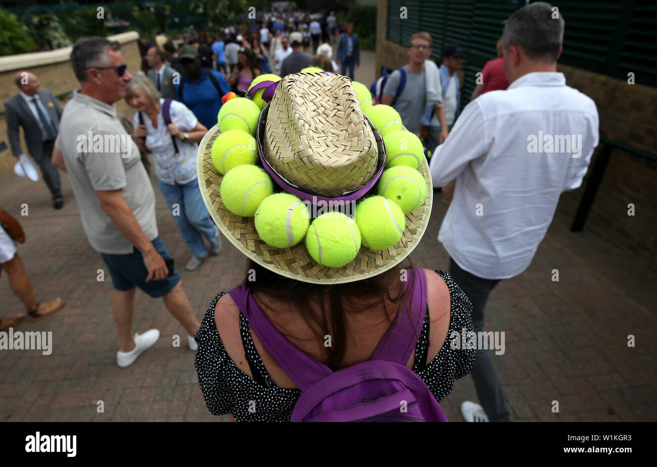 A spectator wears a tennis themed hat on day three of the Wimbledon ...