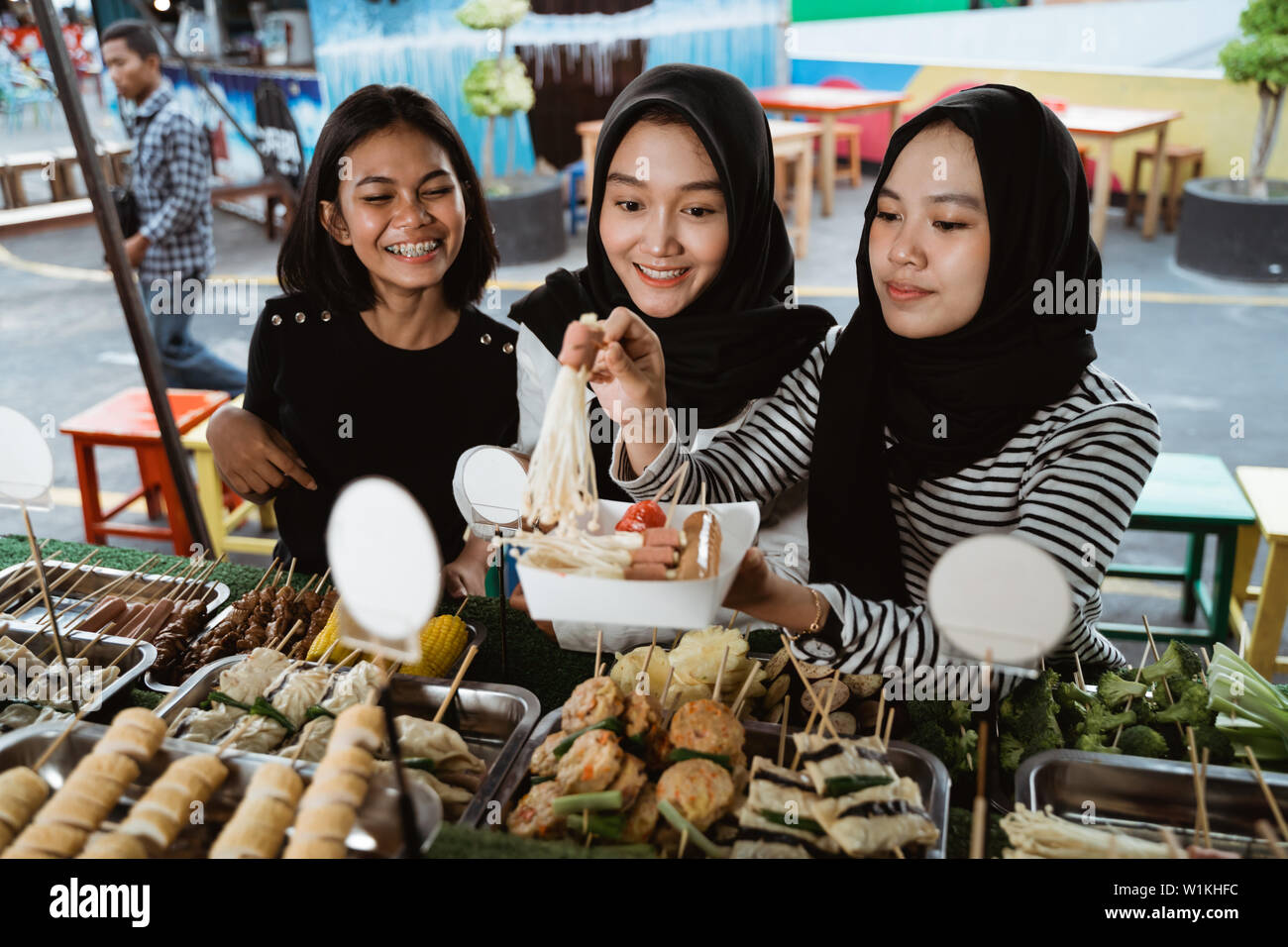 group of young women at a street food restaurant Stock Photo - Alamy
