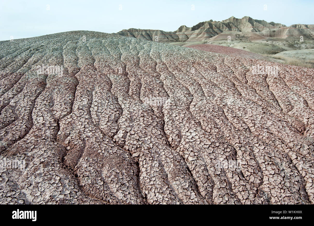 Dried soil and colorful rock layers paint a vibrant texture in Badlands ...