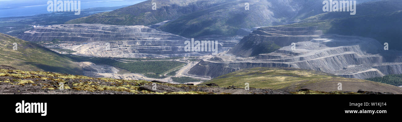 Panorama of mining. Giant crater of ore extraction is screwed into ...
