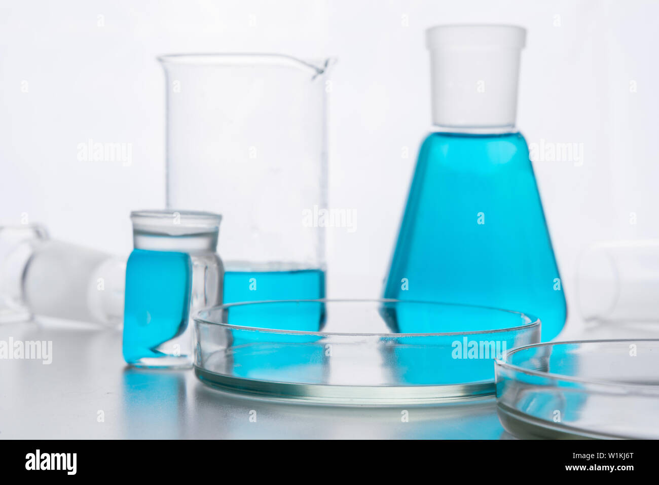 Chemistry glassware with blue liquid for science research and ...