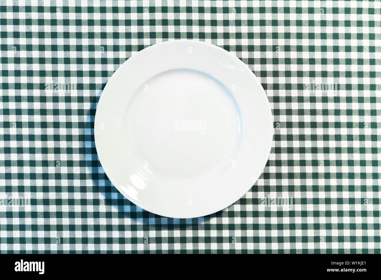 the plate on checkered table cloth Stock Photo - Alamy