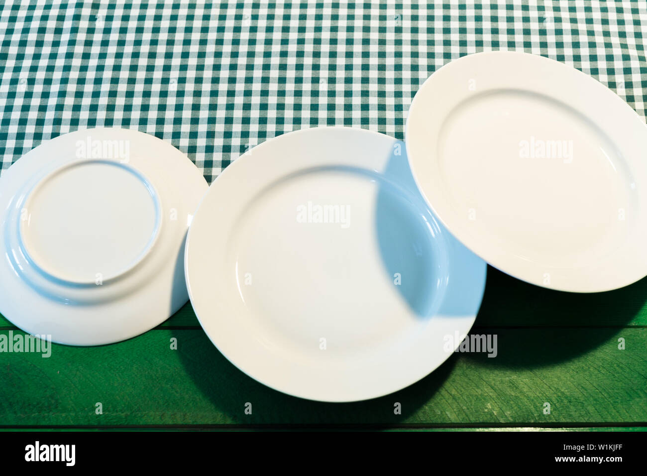 the plate on checkered table cloth Stock Photo - Alamy