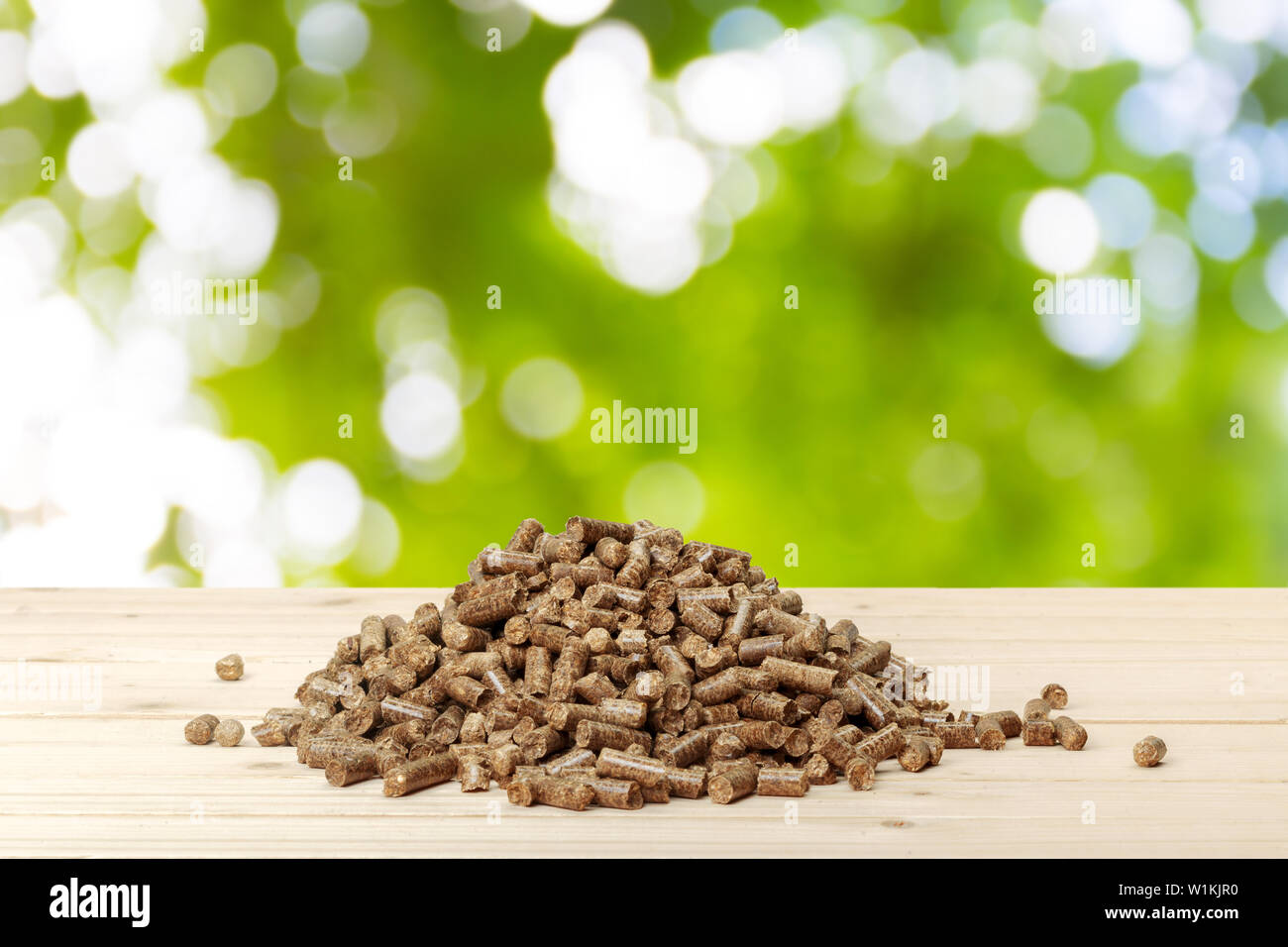 Wood pellets on a green background. Biofuels Stock Photo - Alamy