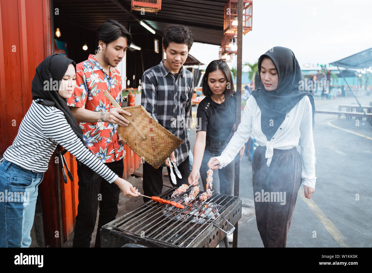 Group of friends grill food with a skewer Stock Photo - Alamy