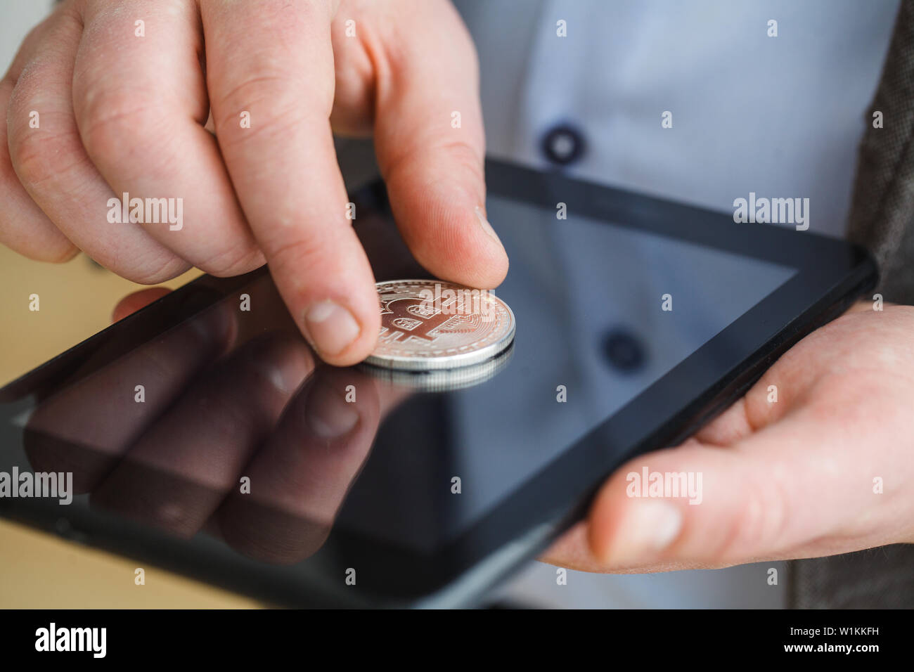 Business man pressing button bitcoin on tablet Stock Photo - Alamy