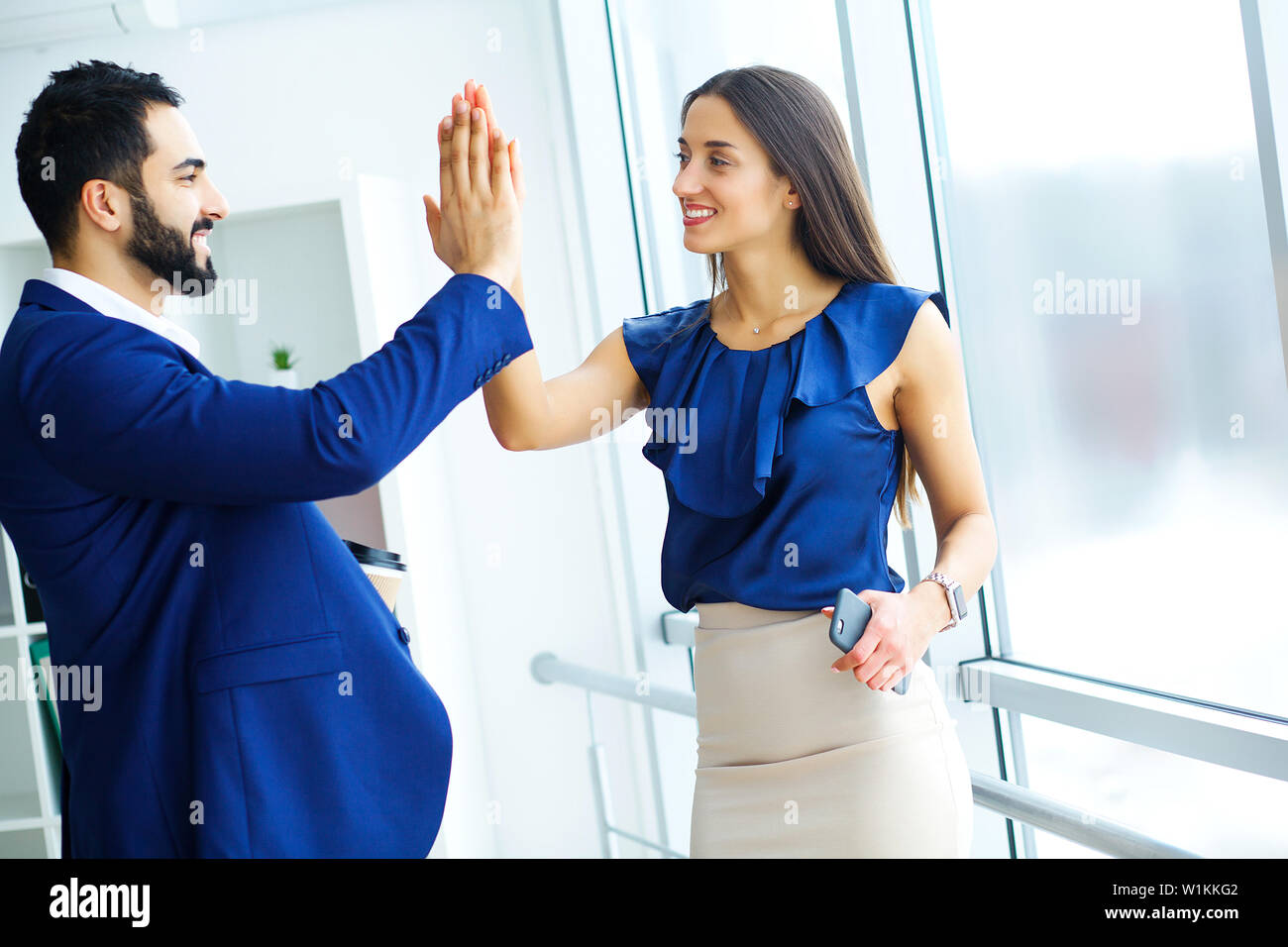 Young colleagues at work in modern office Stock Photo - Alamy