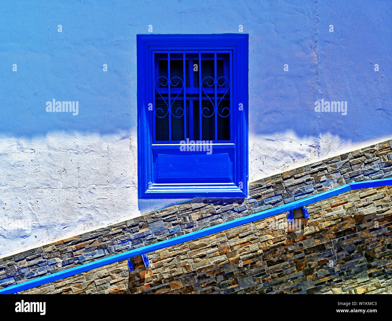 Blue window and diagonal hand rail against white wall Stock Photo - Alamy