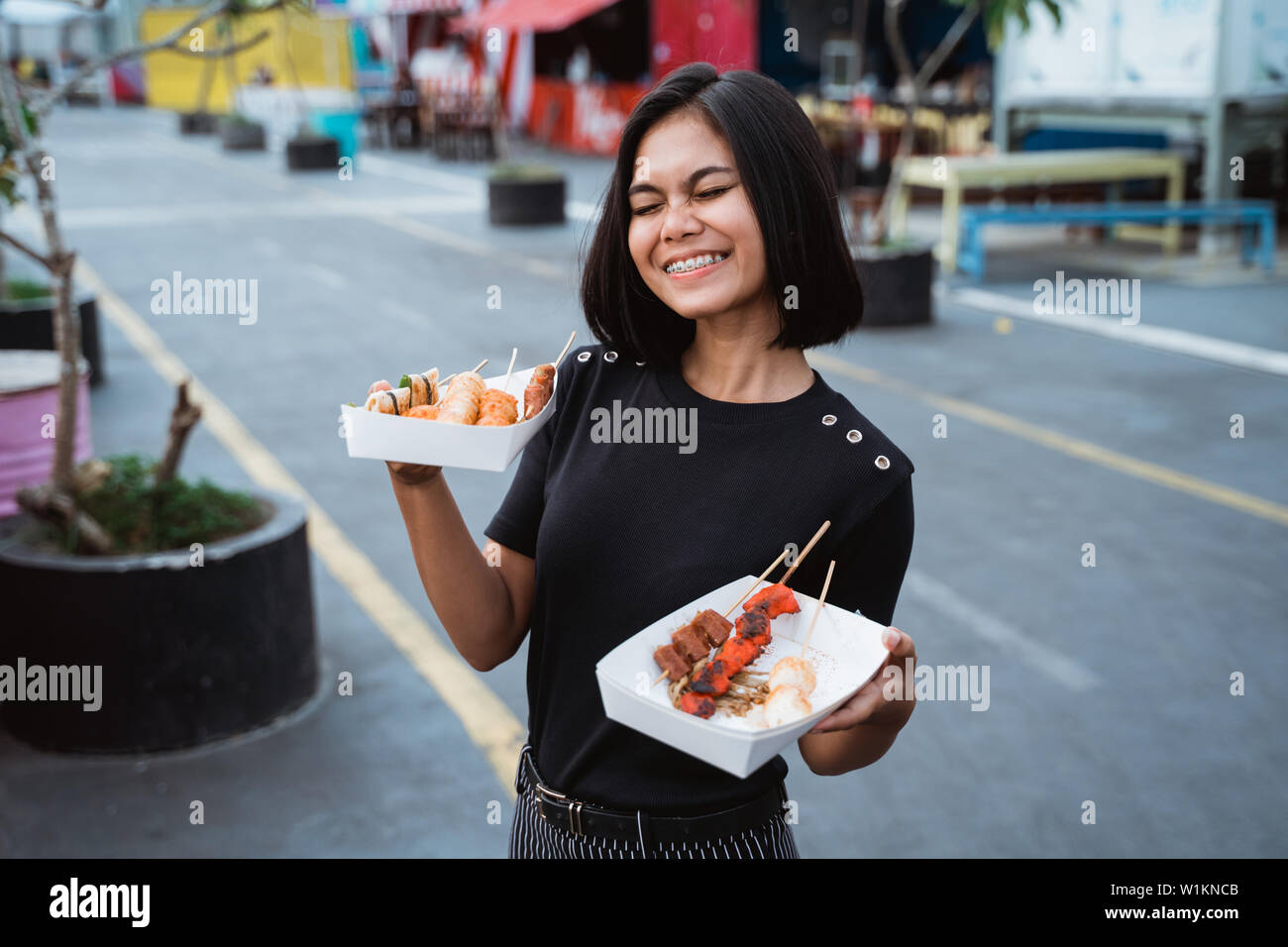 asian woman carrying korean street food Stock Photo - Alamy