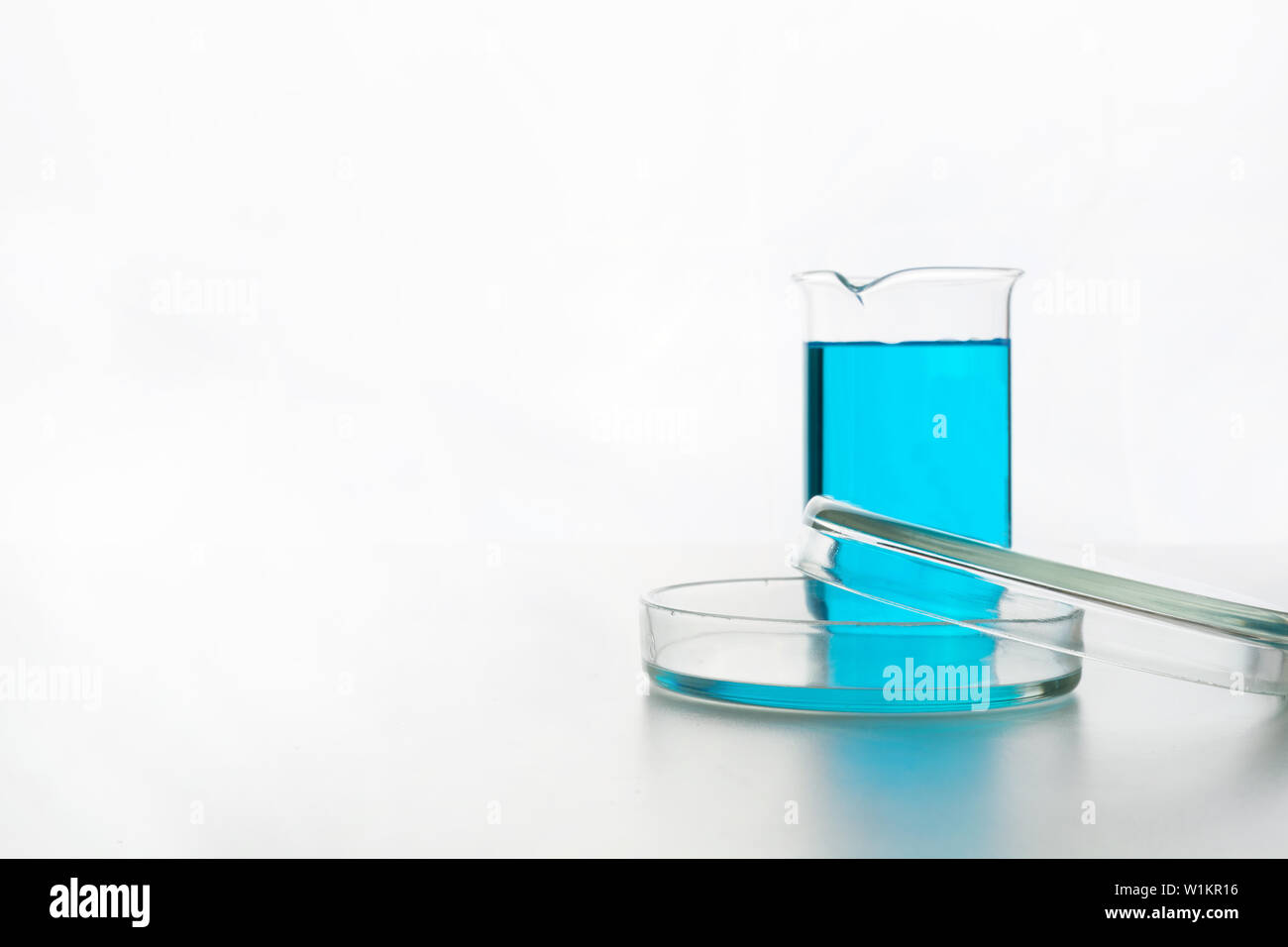 Chemistry glassware with blue liquid for science research and ...