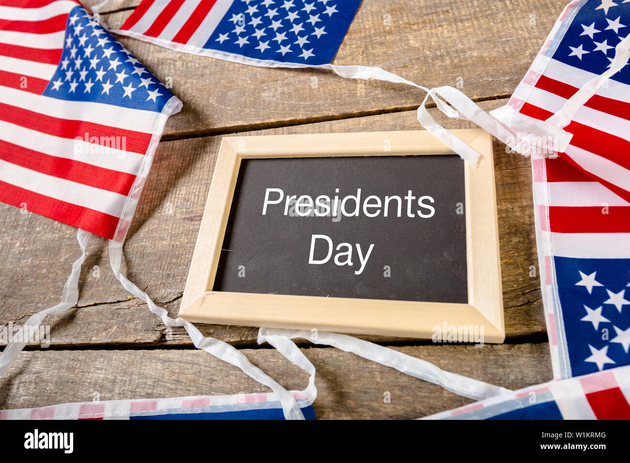 the text happy presidents day written in a chalkboard and a flag of the ...