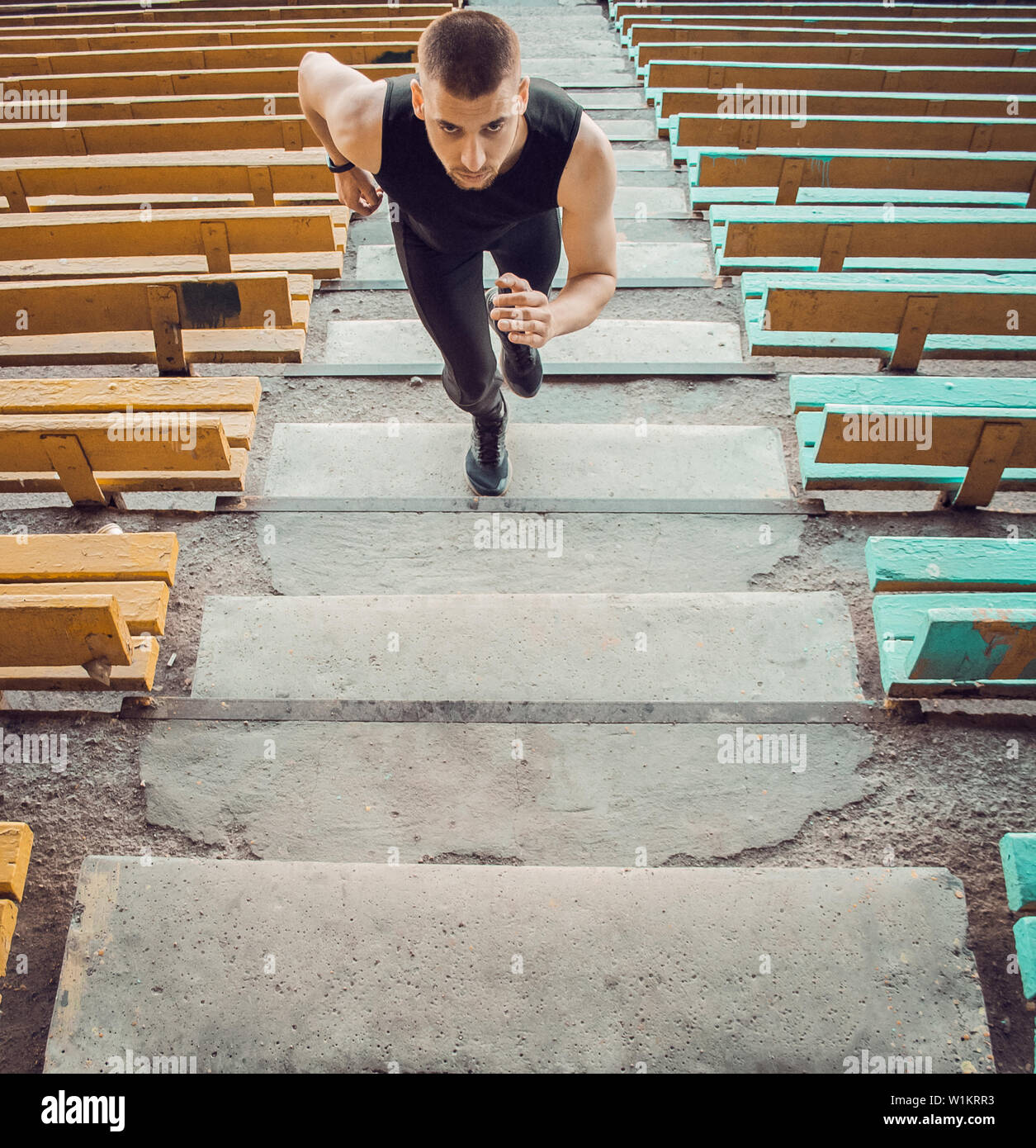 Caucasian man trains in running on the stairs. Track and field runner ...