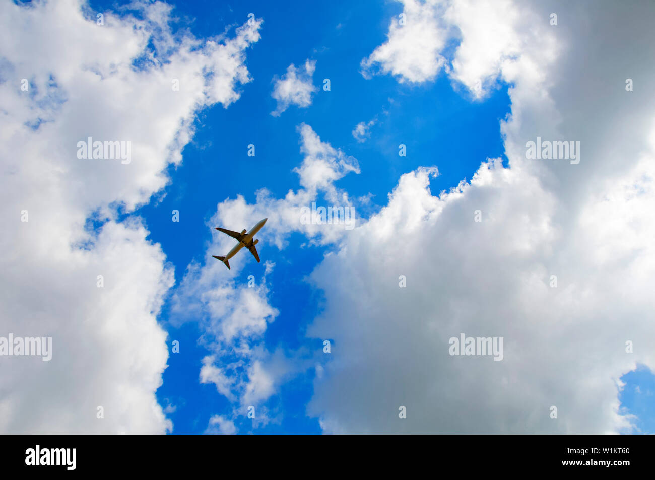 Big grey passenger plane in the blue cloudy sky, summer time Stock ...