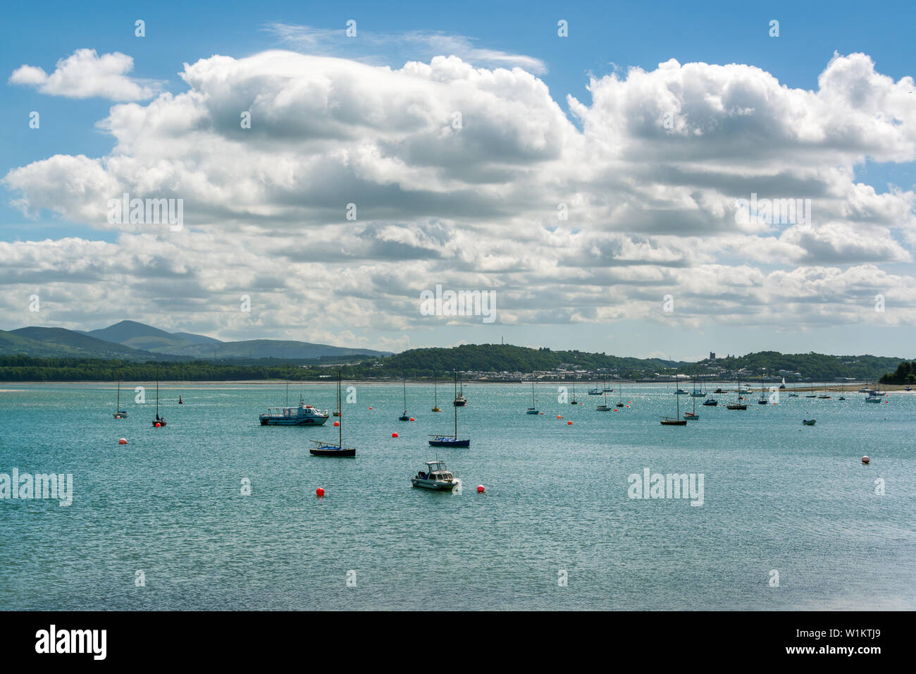 Boats anchored in the clear water of Menai Strait - 2 Stock Photo - Alamy