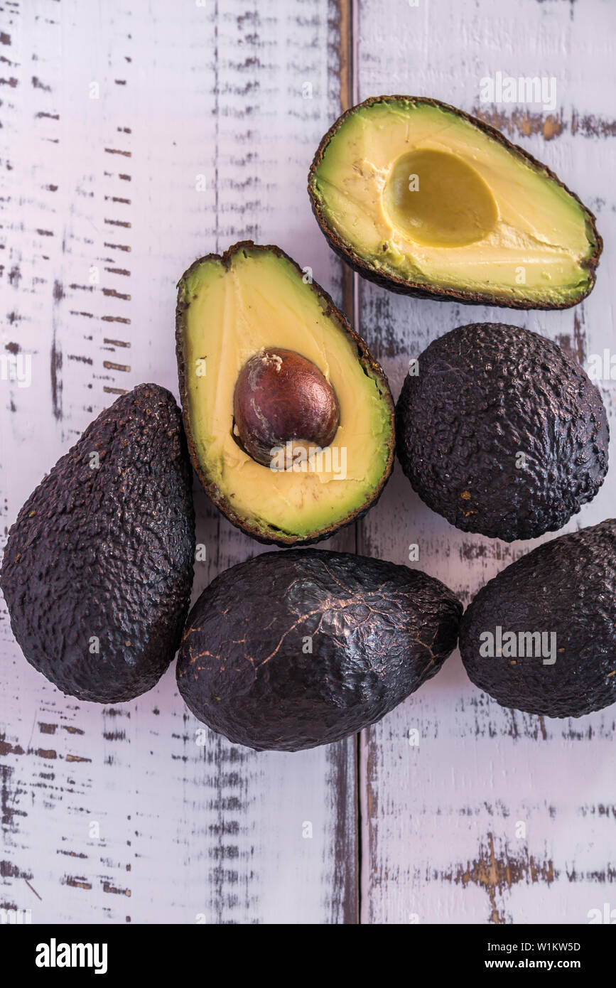 Ripe avocados on a with wooden background Stock Photo - Alamy