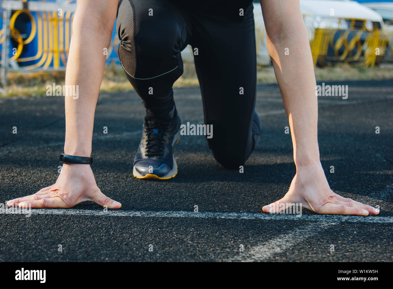 one runner on the starting line on the stadium track is waiting to ...