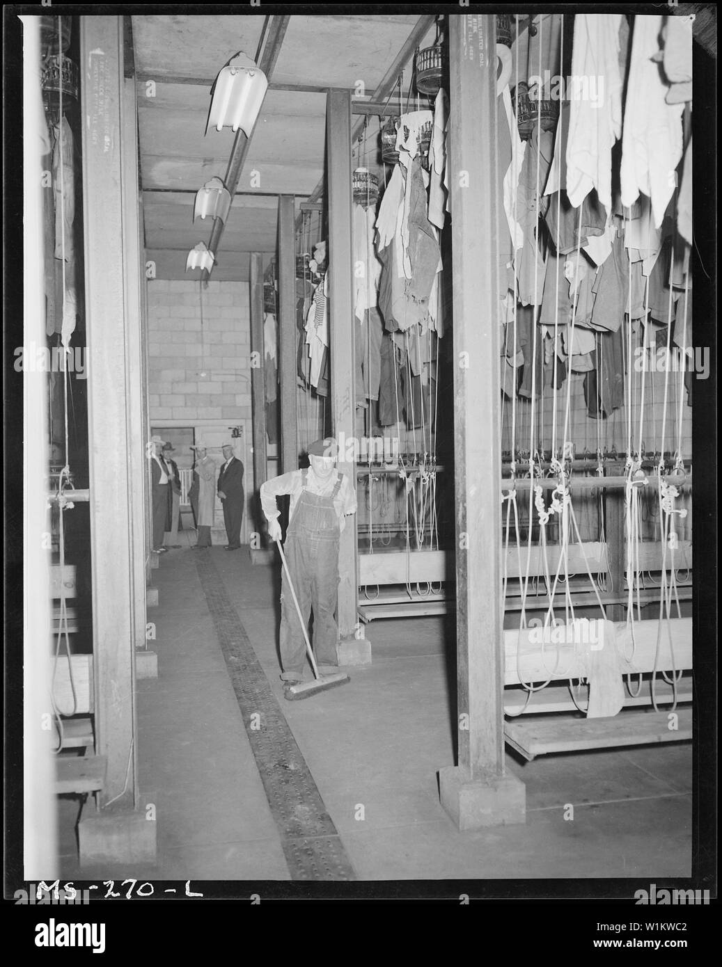 Wash and change house is swept by miner who formerly worked underground ...