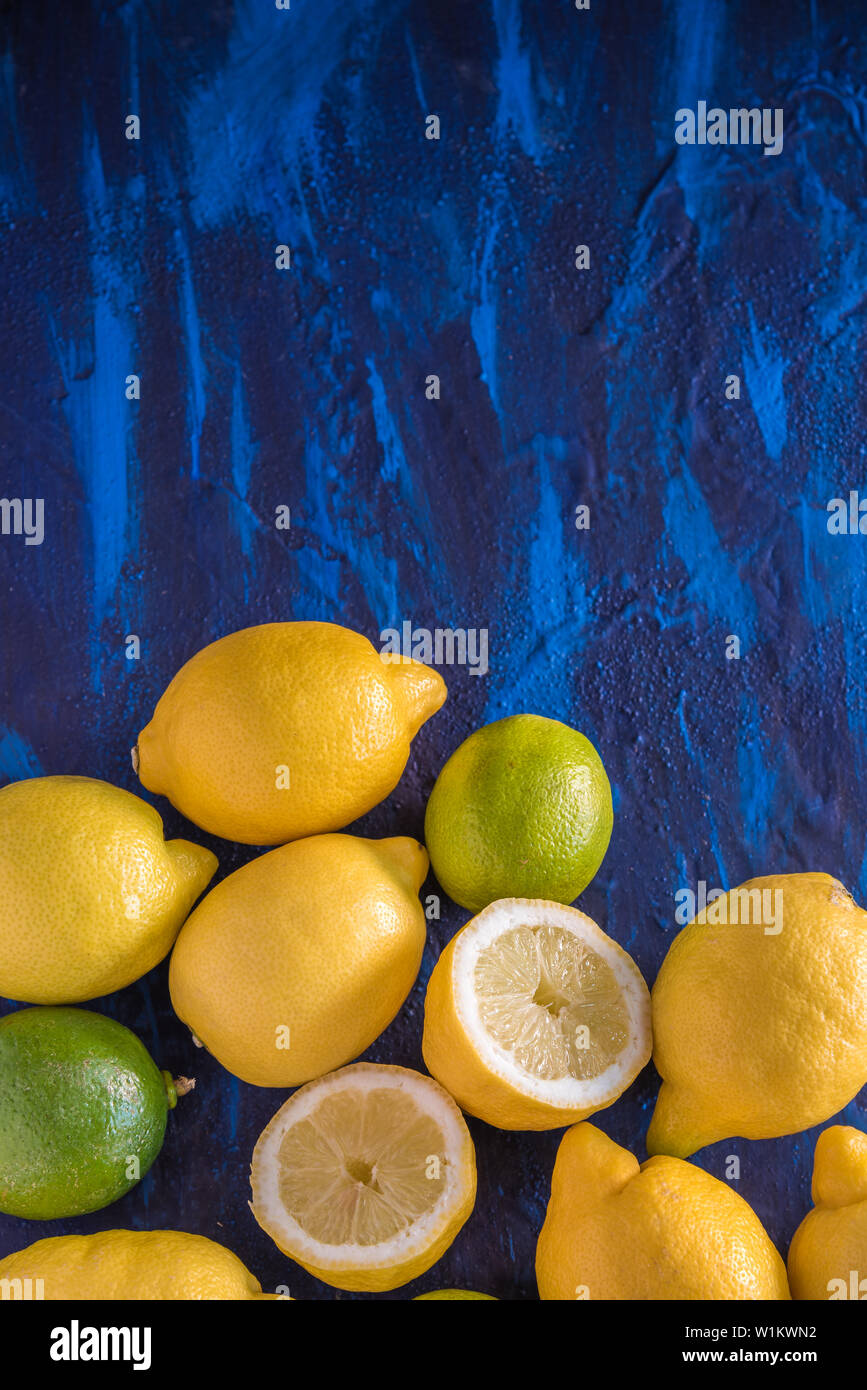 Lemon and limes on a blue background Stock Photo - Alamy