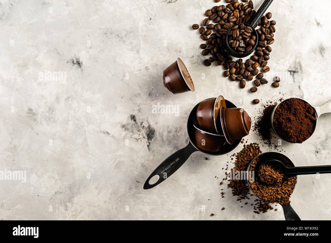Coffee concept - beans, ground, instant, capsules, marble background ...