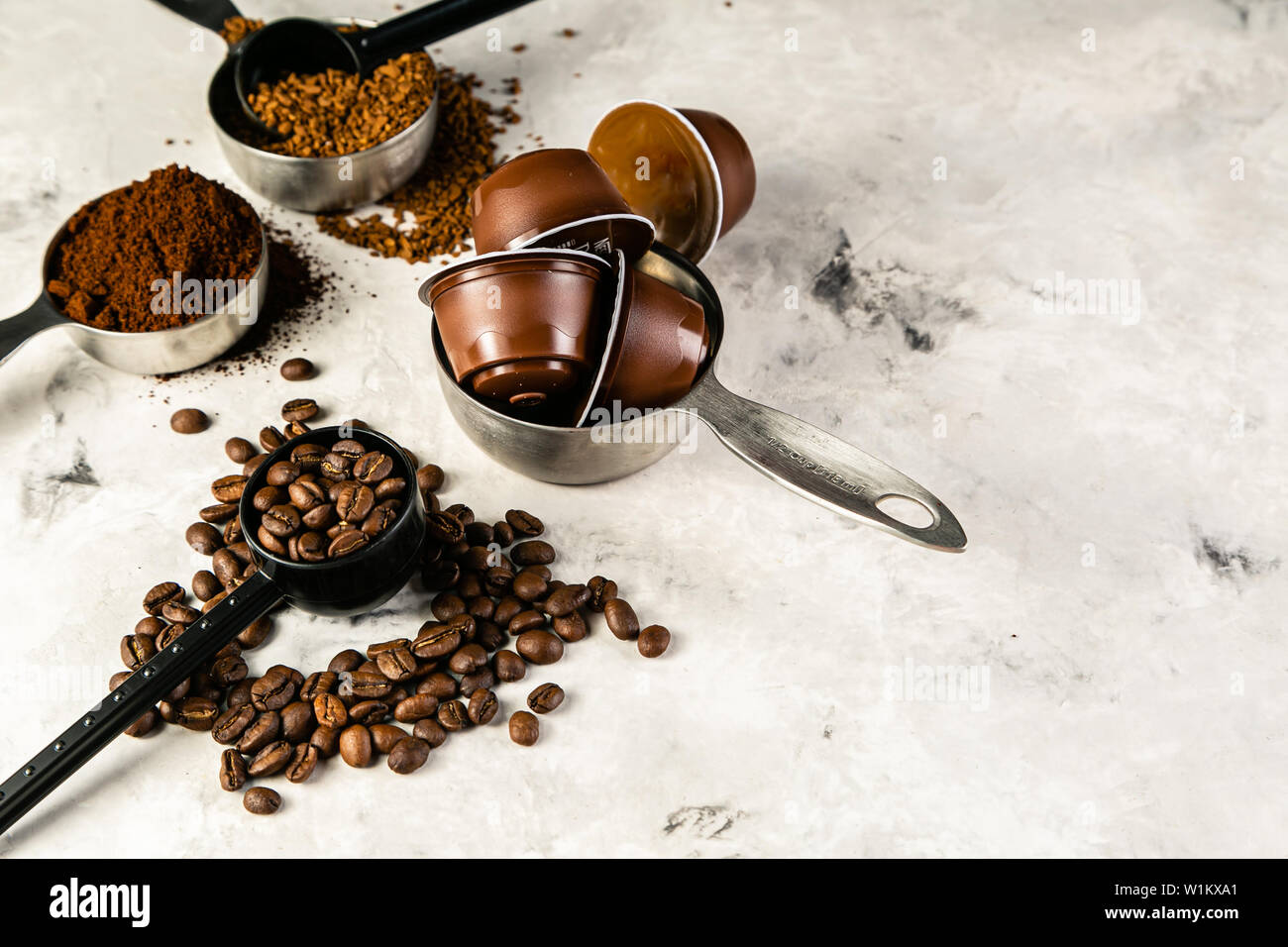 Coffee concept - beans, ground, instant, capsules, marble background ...